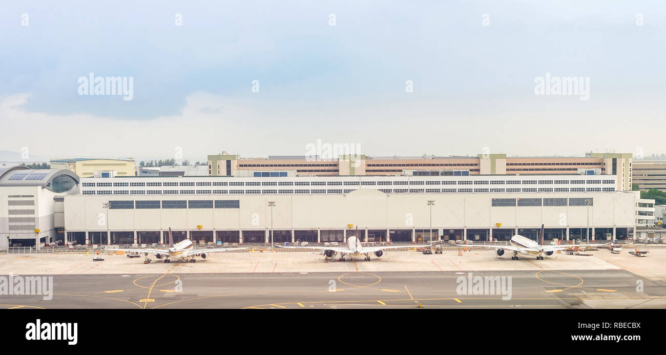 Airplanes at runway by Changi international airport terminal, Singapore ...