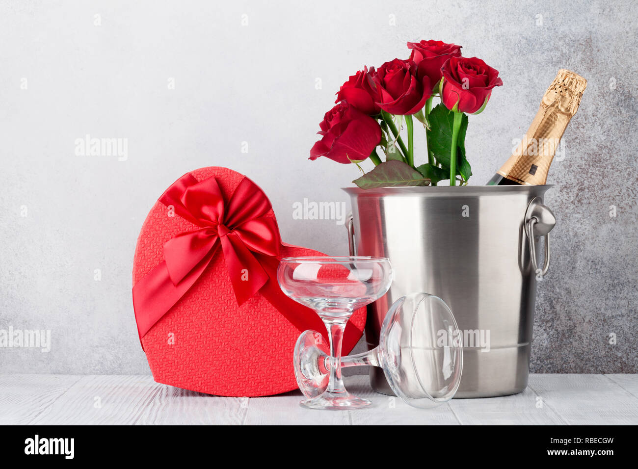 Valentine's day greeting card with champagne in bucket and rose flowers ...