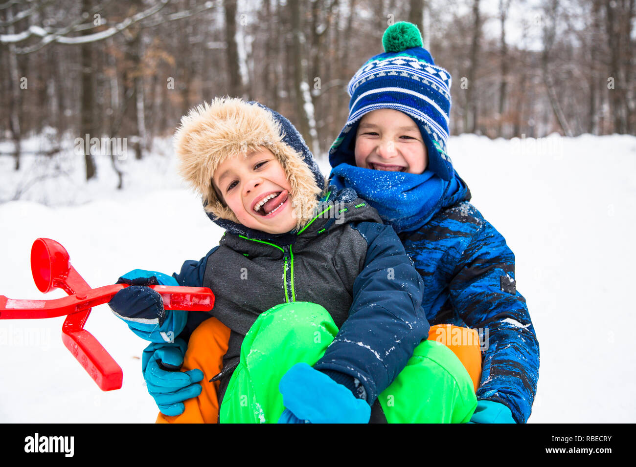 Winter child boys playing outdoor in winter clothes Stock Photo - Alamy