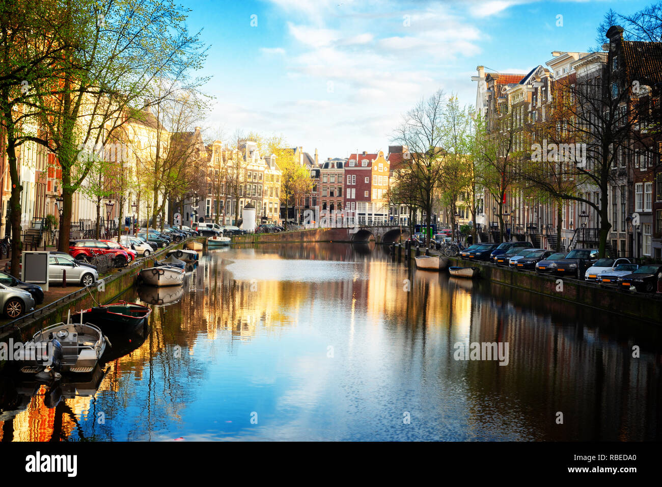 Dutch spring city scenery with canal and mirror reflections, Amsterdam ...