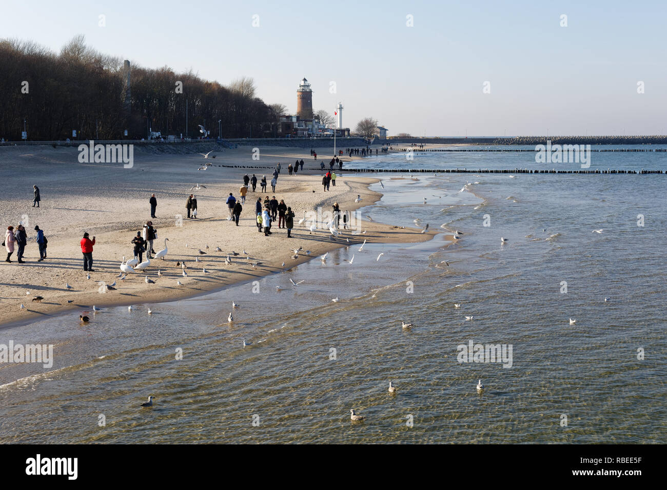 People winter walking by long sand beach at Baltic Sea Stock Photo - Alamy