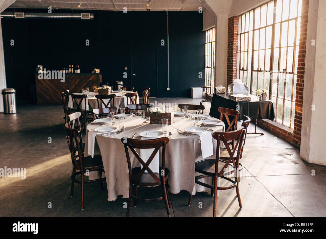 empty dinner tables next to large windows in banquet hall Stock Photo ...