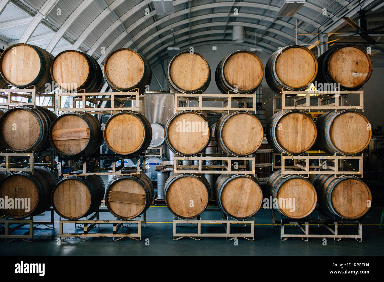 large wine barrels stacked in big open room Stock Photo - Alamy