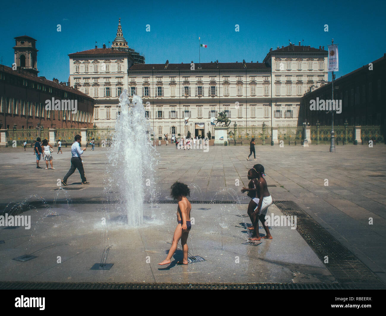 Kids playing in the fountain on a hot day in front of The Royal Palace ...