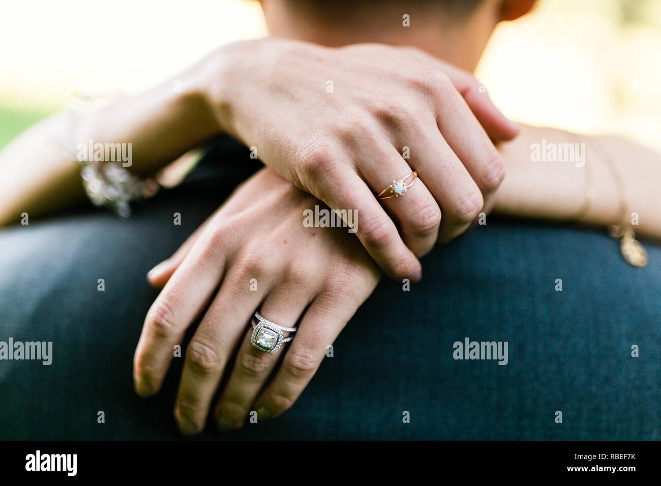 womans arms around man shoulders kissing Stock Photo - Alamy