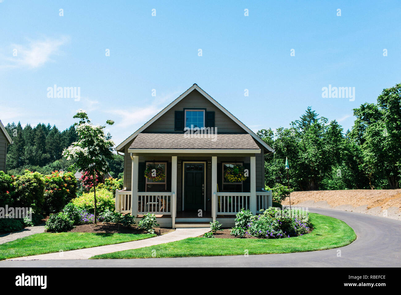 tiny house with well-kept yard during daytime Stock Photo - Alamy