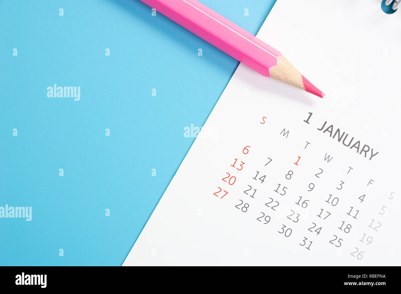 red pencil and calendar on blue background Stock Photo - Alamy