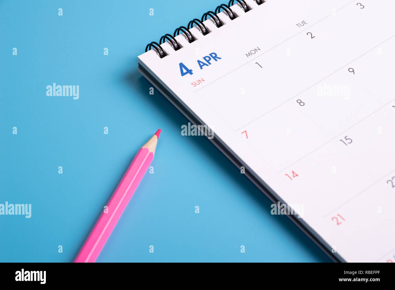 red pencil and calendar on blue background Stock Photo - Alamy