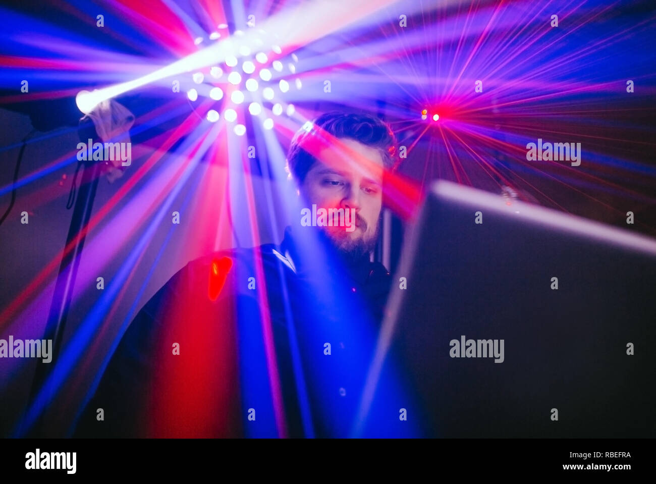 dj at a party with fog and disco lights on computer Stock Photo - Alamy