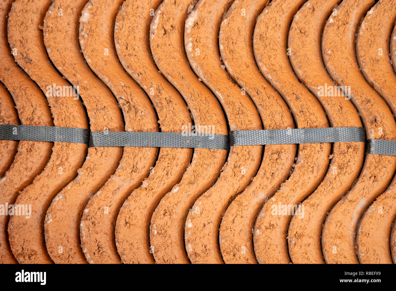 construction material - building material - bundles of red roof tiles ...