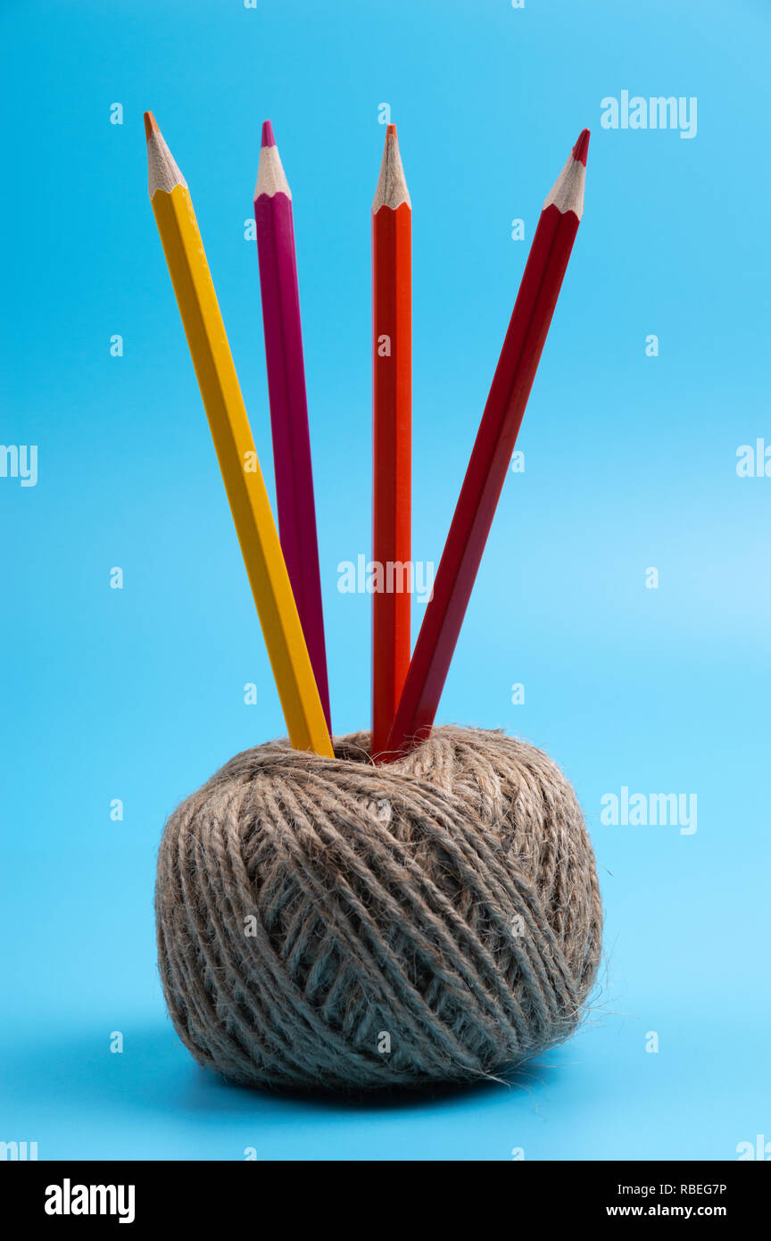 color pencils and string basket on blue background Stock Photo - Alamy