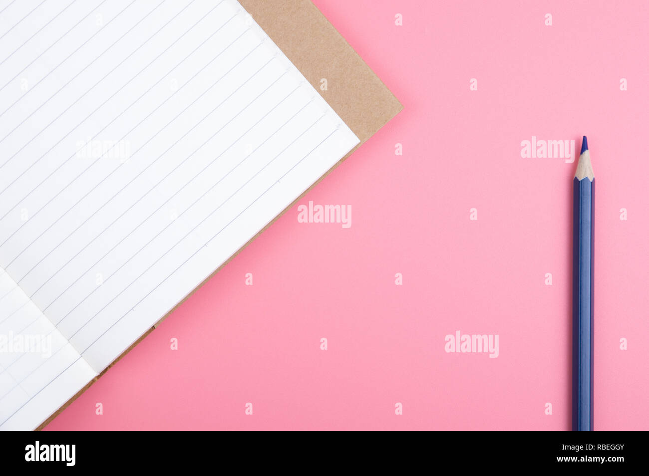 note and blue color pencil on red background Stock Photo - Alamy