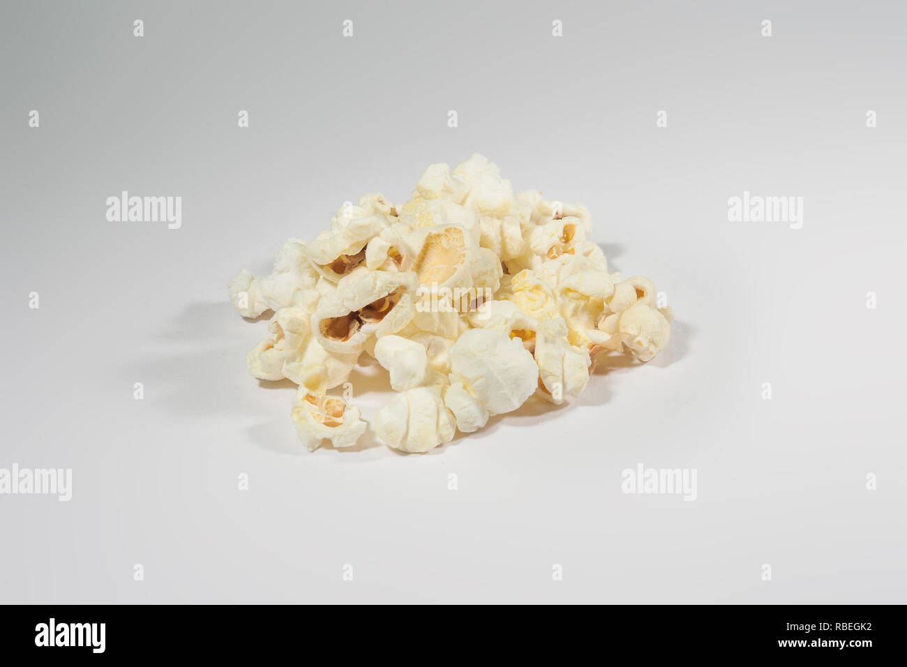 Salty Popcorn on Grey Background on White Stock Photo - Alamy
