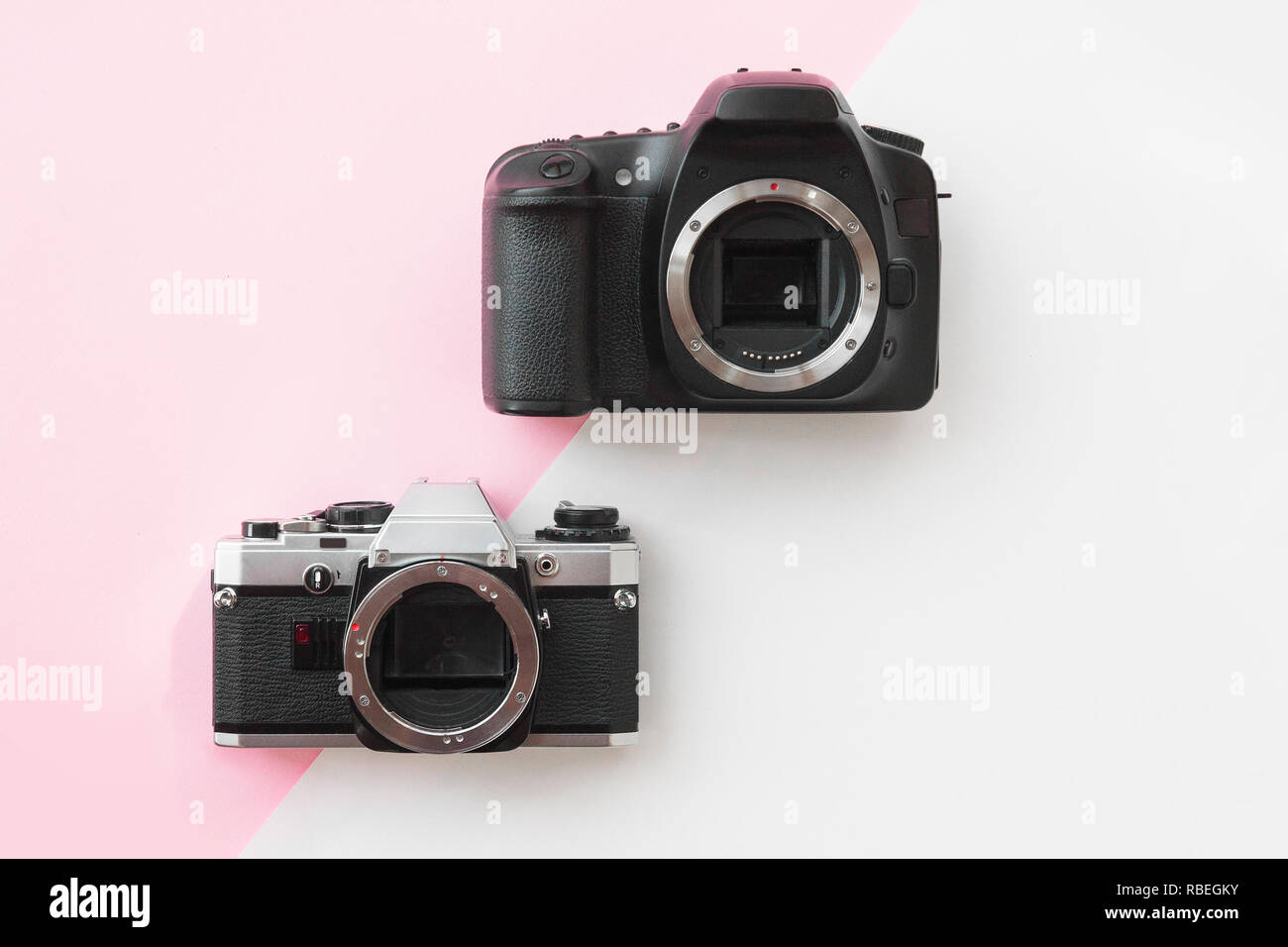 Concept - Digital vs. Analog SLR Camera on Pink Back Stock Photo - Alamy