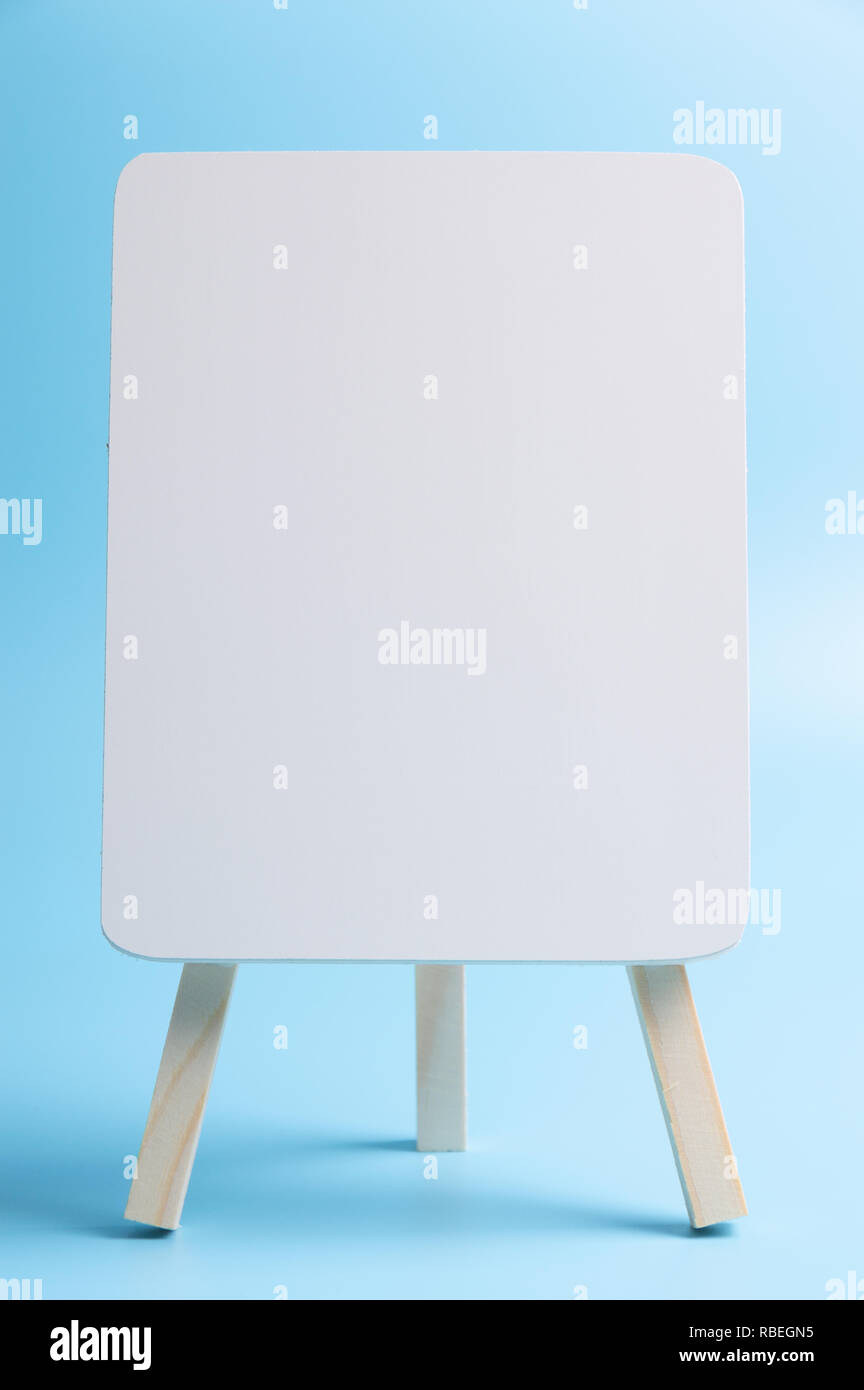 white easel front blue background Stock Photo - Alamy