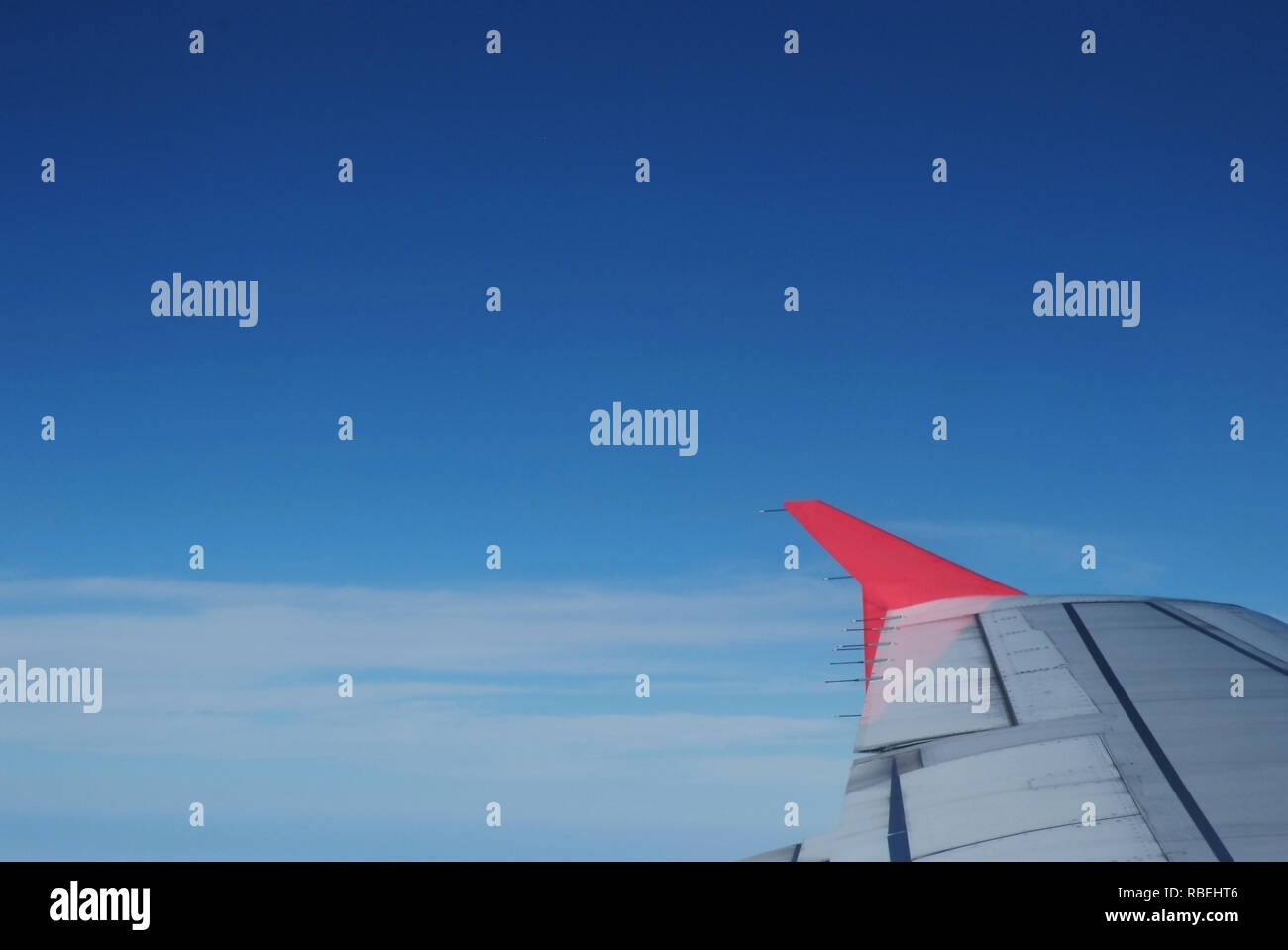 Red wing plane on blue sky,view from the window of a plane of the blue ...