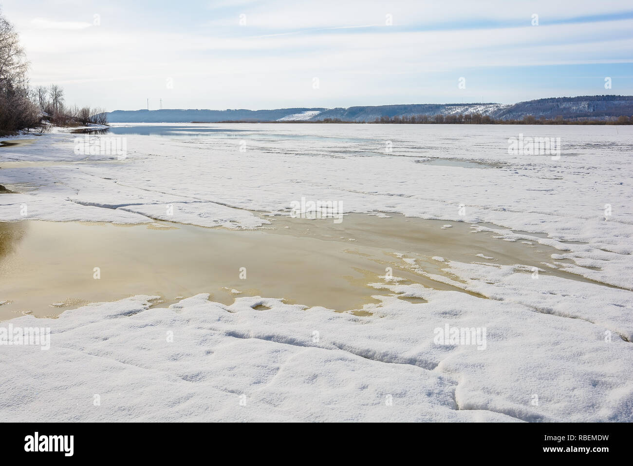 The river beach is flooded in the spring with melted snow and ice Stock ...