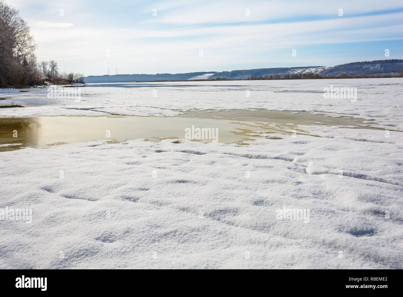 The river beach is flooded in the spring with melted snow and ice Stock ...