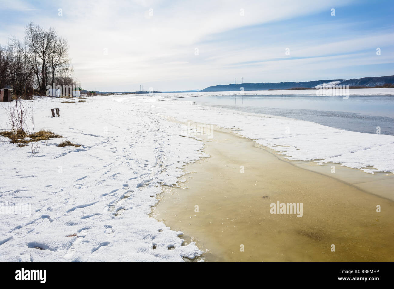 The river beach is flooded in the spring with melted snow and ice Stock ...