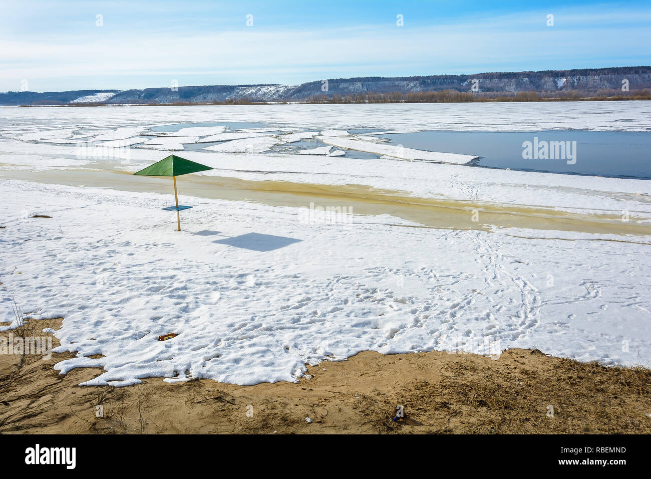 The river beach is flooded in the spring with melted snow and ice Stock ...