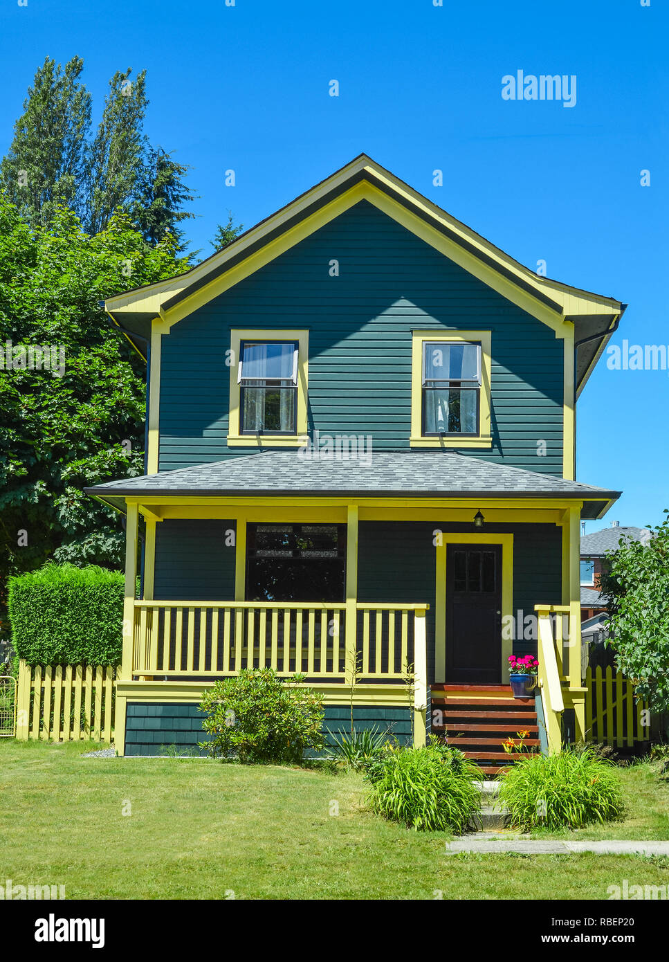 Modest family house with concrete pathway and blue sky background Stock ...