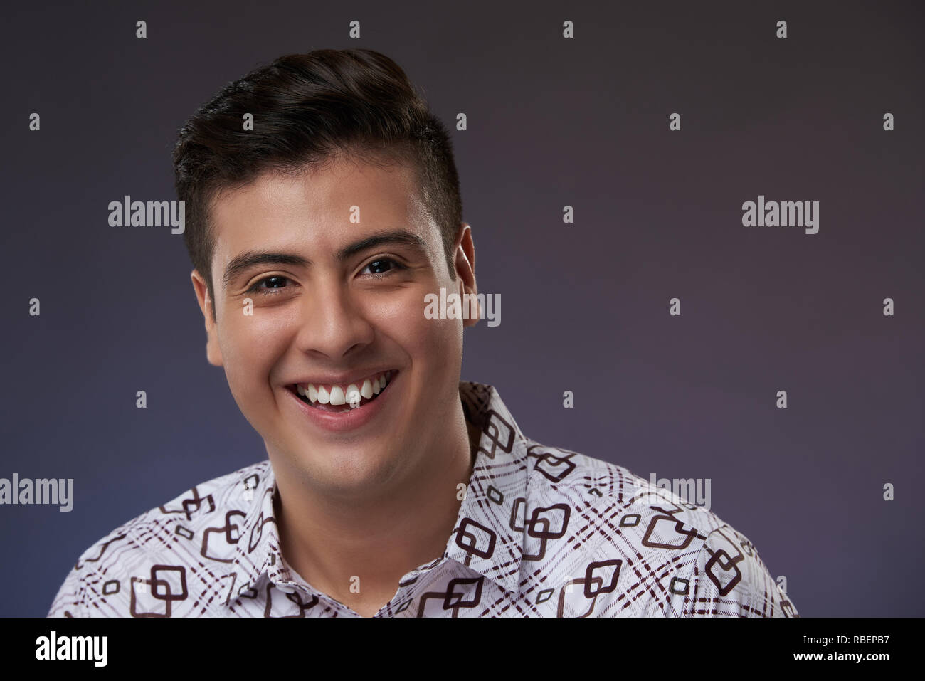 Face of young smiling guy on studio background Stock Photo - Alamy