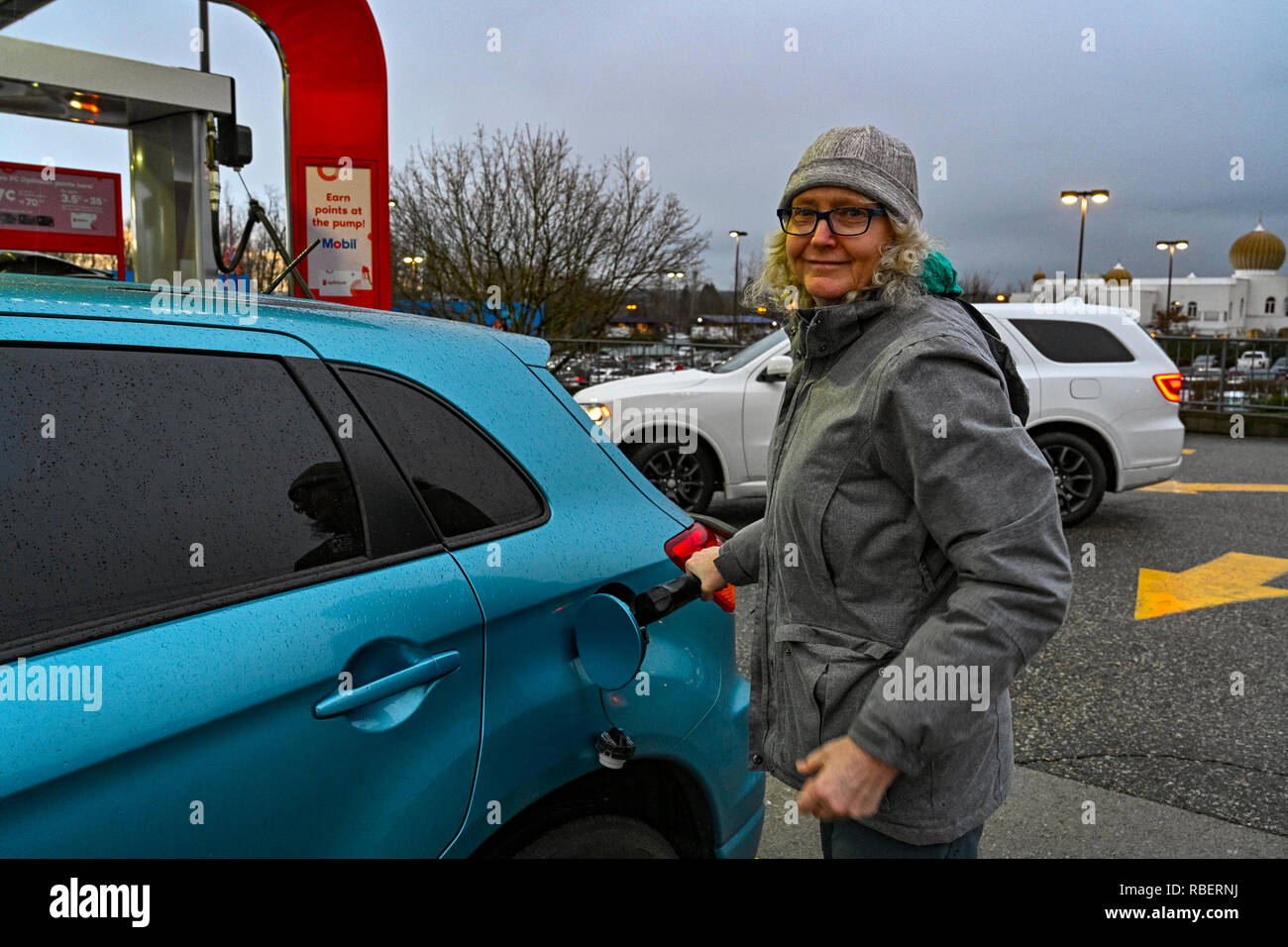 woman pumping gas Stock Photo - Alamy