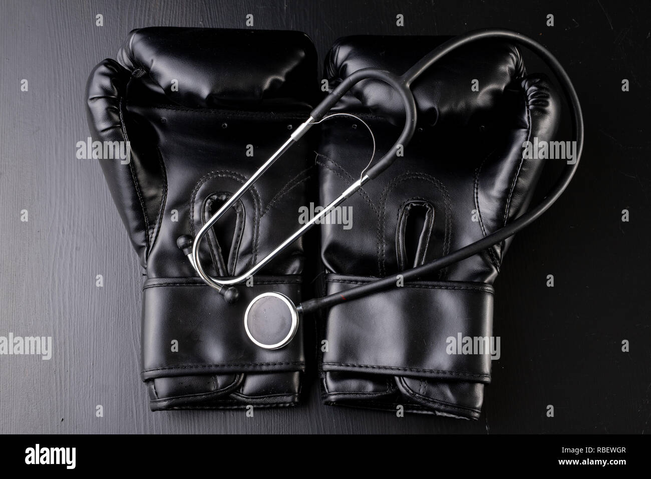 Black boxing gloves and a medical stethoscope. Training accessories ...