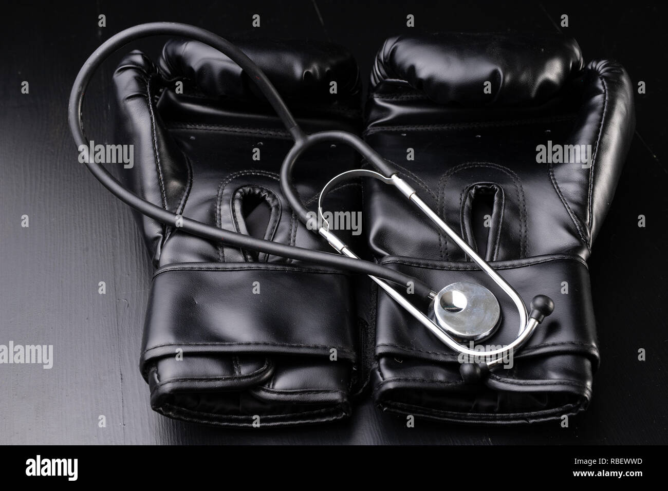 Black boxing gloves and a medical stethoscope. Training accessories ...