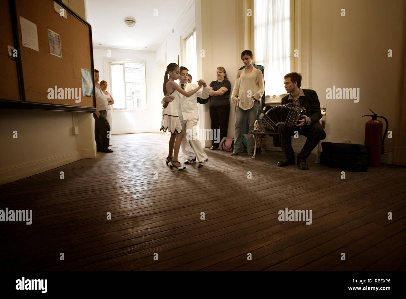 Side view of two children dancing as a group of people looks on Stock ...