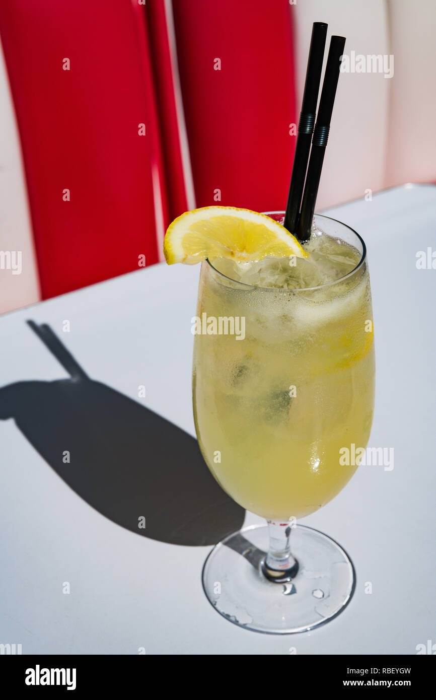 A glass of refreshing lemonade on a hot summer's day. Photo has a retro ...