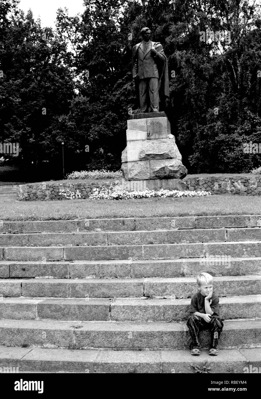 Boy sitting on steps Stock Photo - Alamy