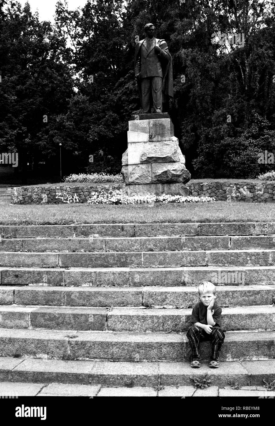 Boy sitting on steps Stock Photo - Alamy