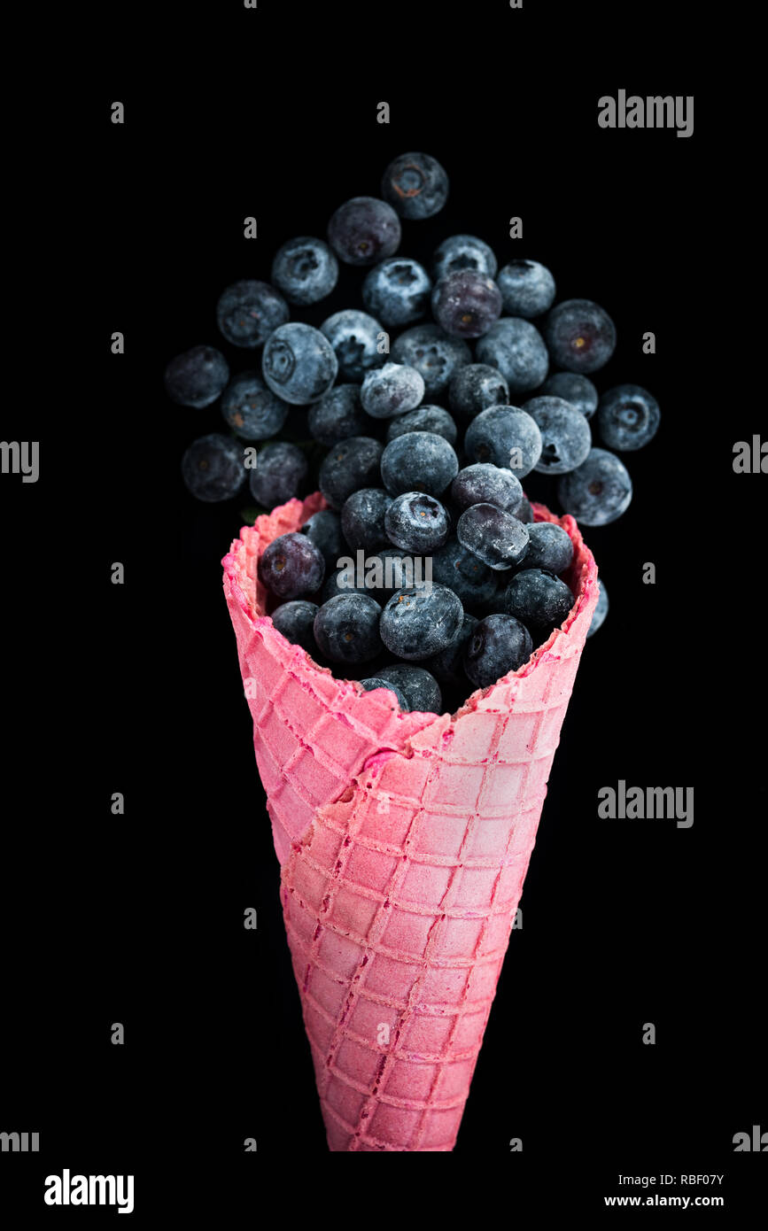 Pink wafer cone with frozen blueberry fruits. Healthy ice cream Stock ...