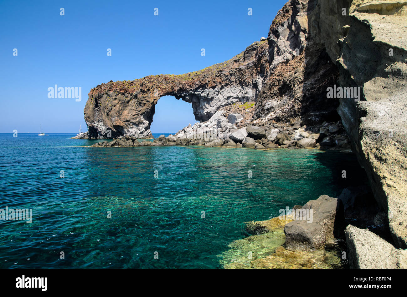 Punta Perciato natural volcanic arch formed from lava on the crystal ...