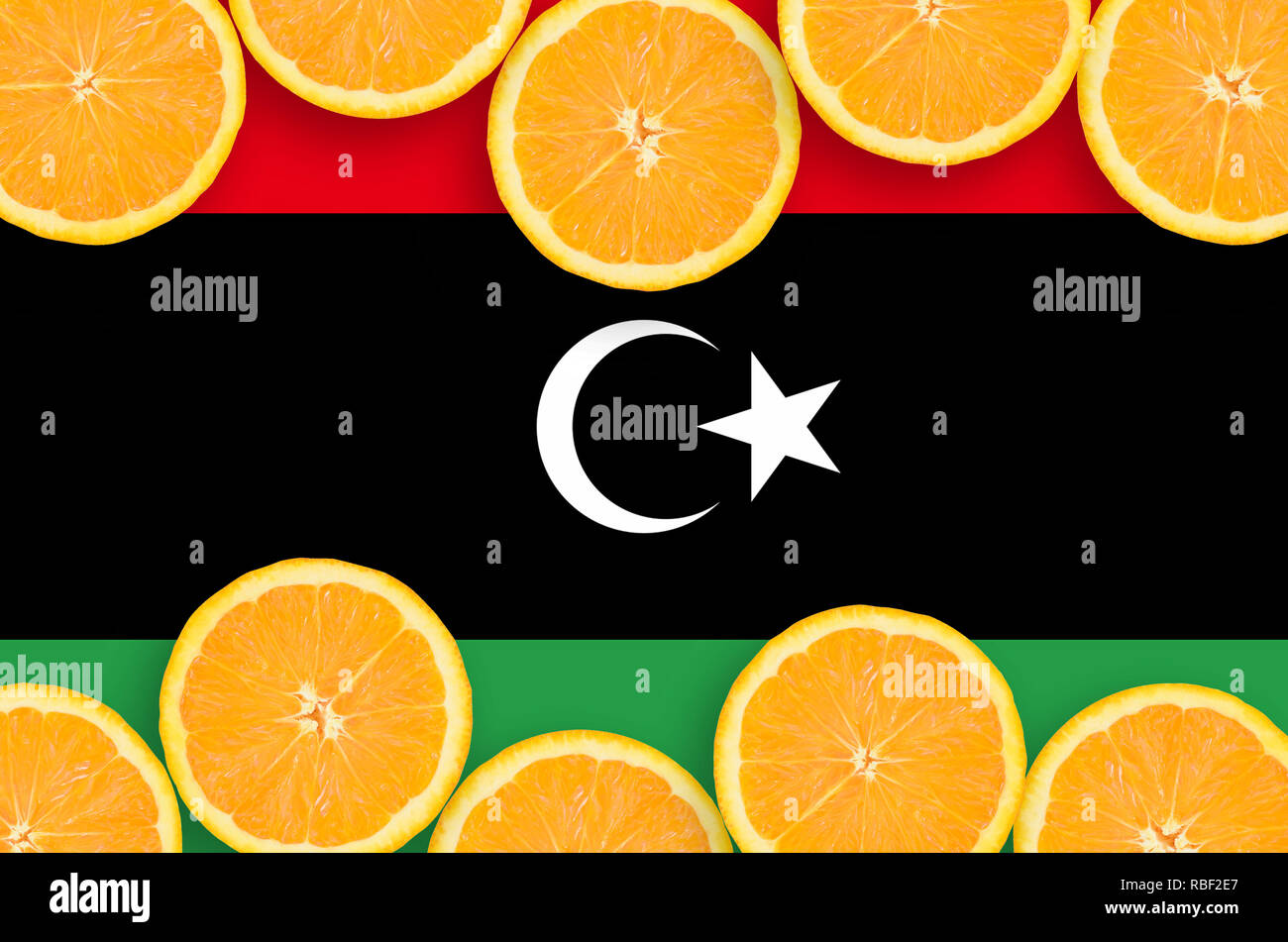 Libya flag in horizontal frame of orange citrus fruit slices. Concept ...