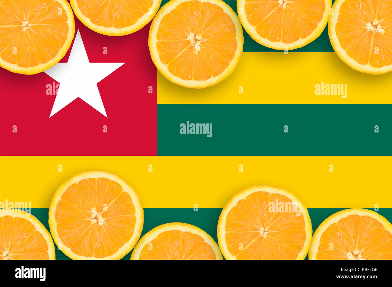 Togo flag in horizontal frame of orange citrus fruit slices. Concept of ...
