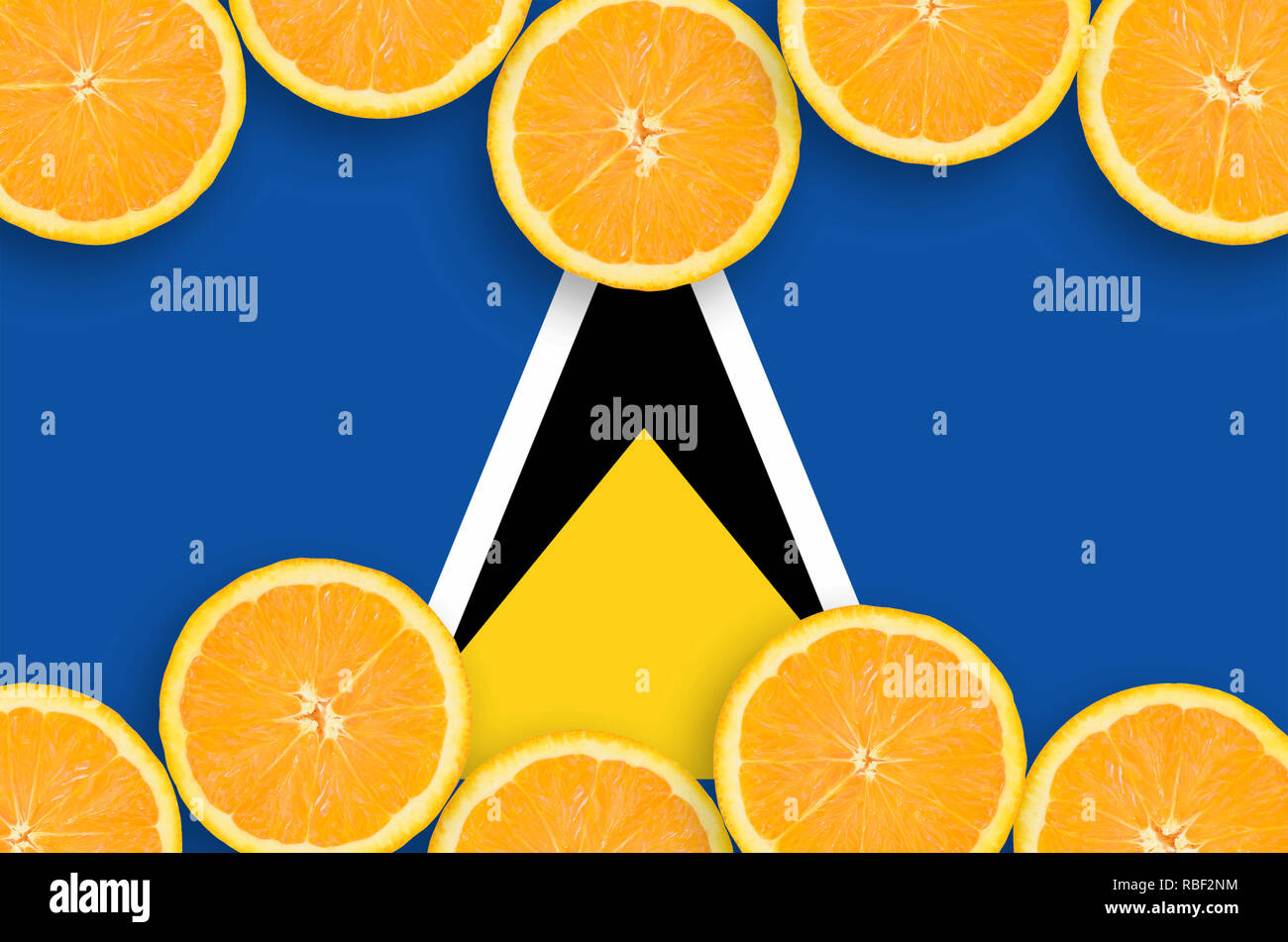 Saint Lucia flag in horizontal frame of orange citrus fruit slices ...