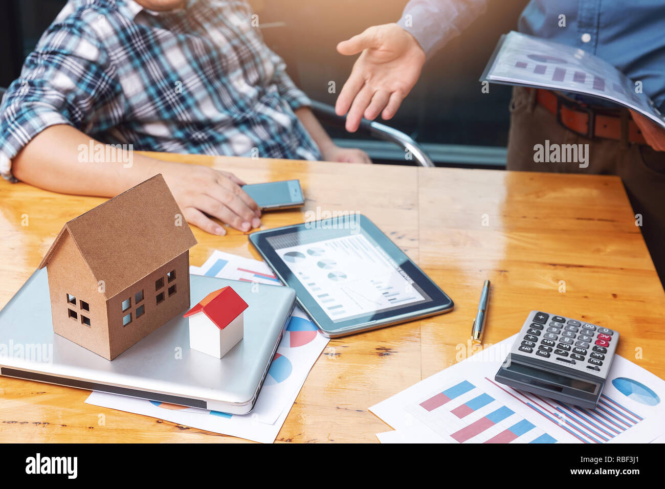 Real estate agent showing his client about property detail Stock Photo ...