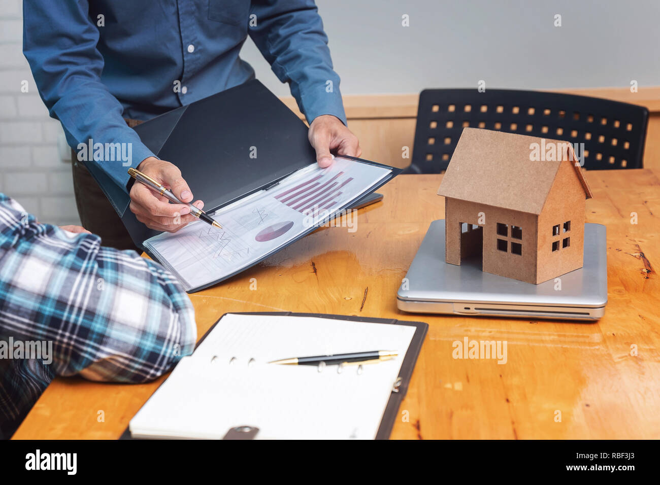 Real estate agent showing his client about property detail Stock Photo ...