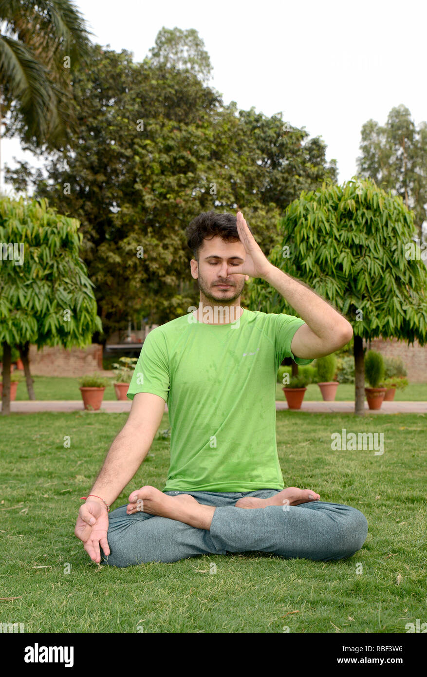 Young man meditating Stock Photo - Alamy