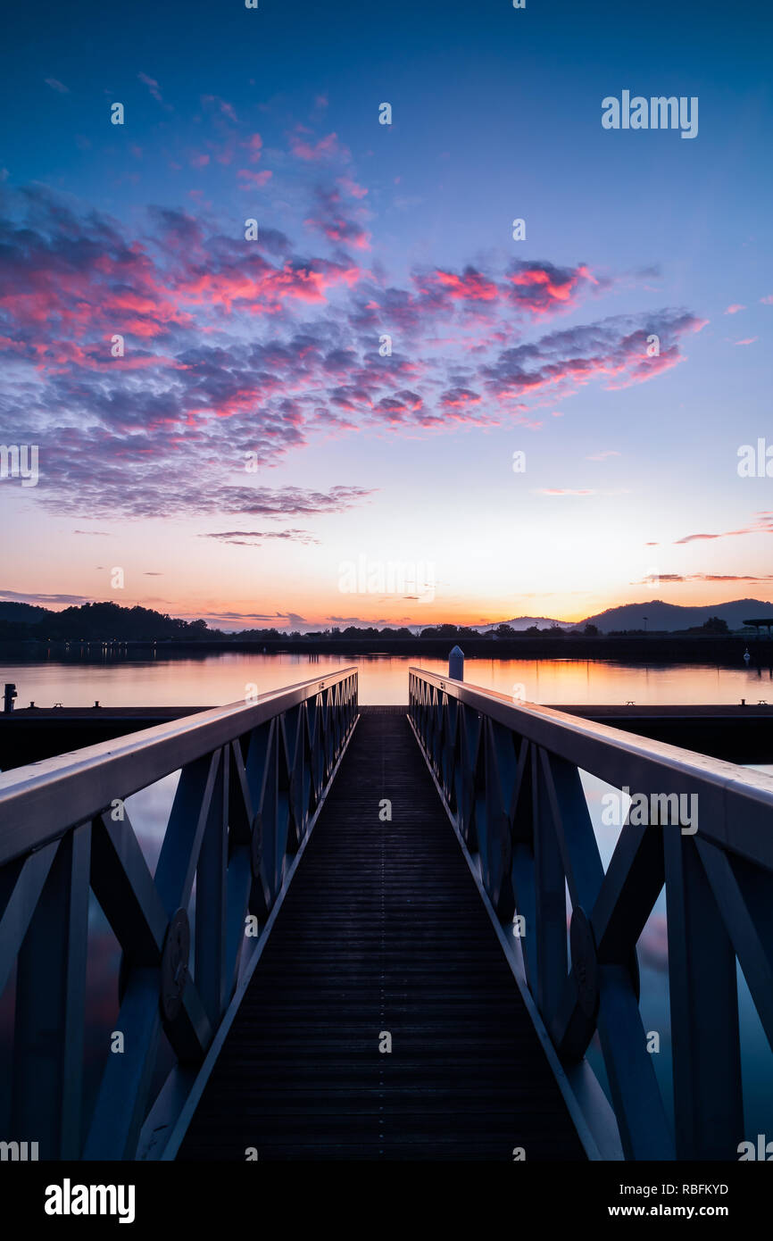 Structure of the jetty leading to the beautiful sunrise glow Stock ...