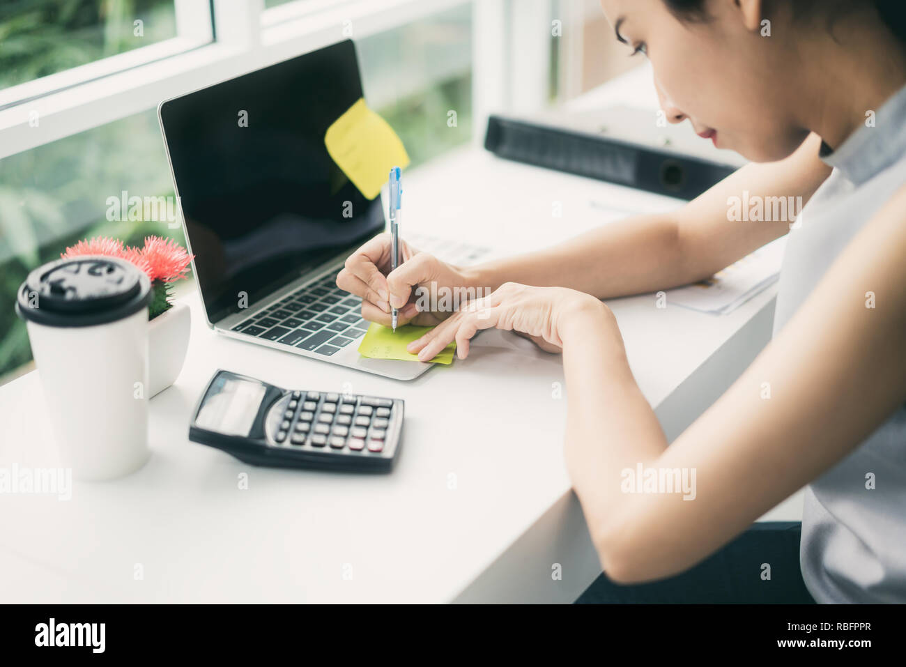 Woman writing post it note hi-res stock photography and images - Alamy
