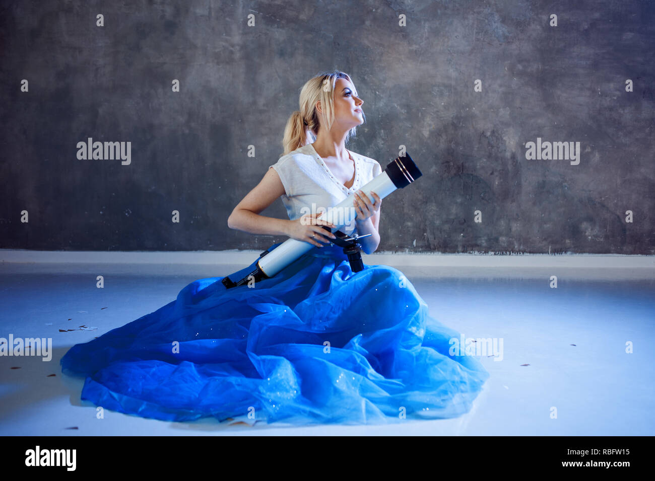 Young woman dreams of the future, concept. Girl looks up and uses a ...