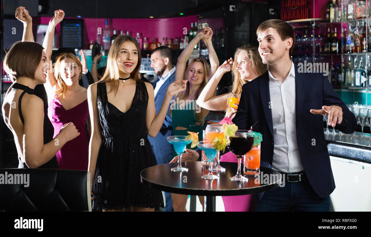 Happy friendly smiling colleagues dancing on corporate party with ...