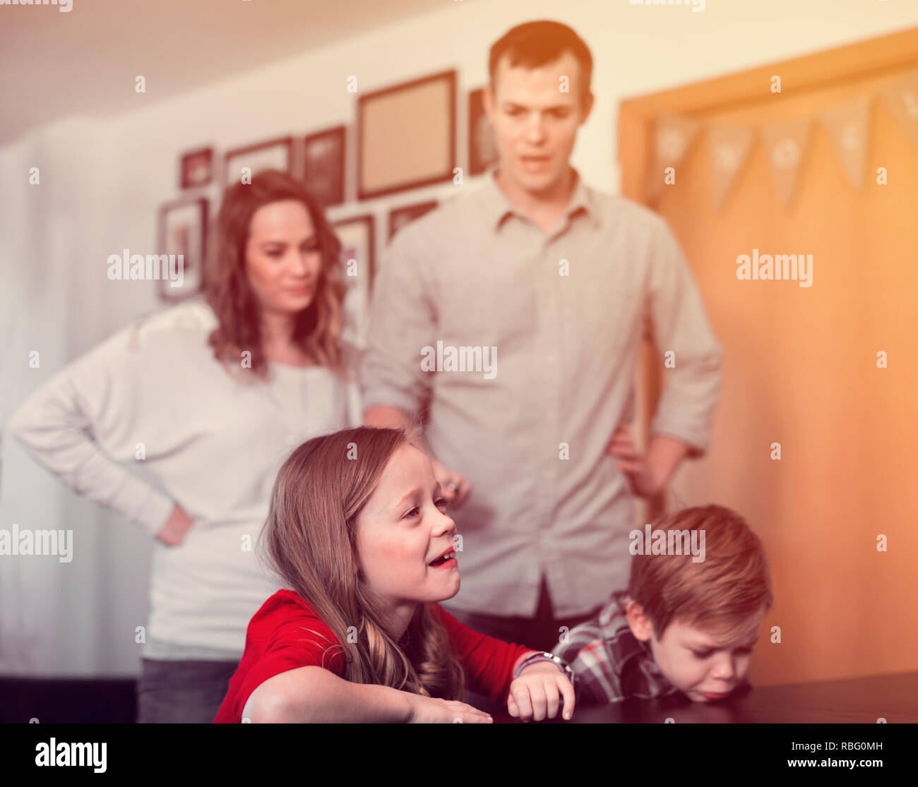 Young parents lecturing their children for bad behavior at home Stock ...