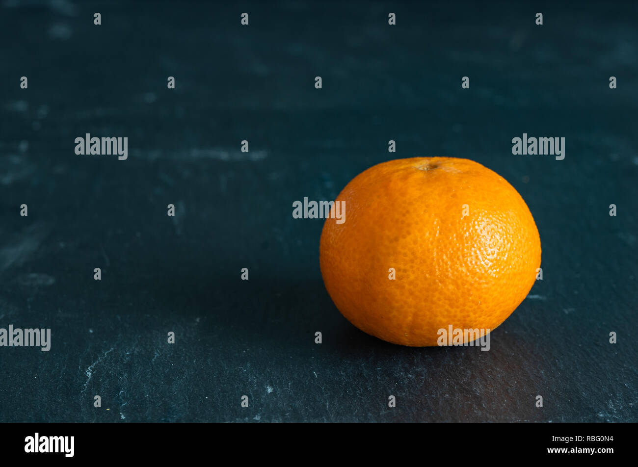 Mandarin on a dark background Stock Photo - Alamy