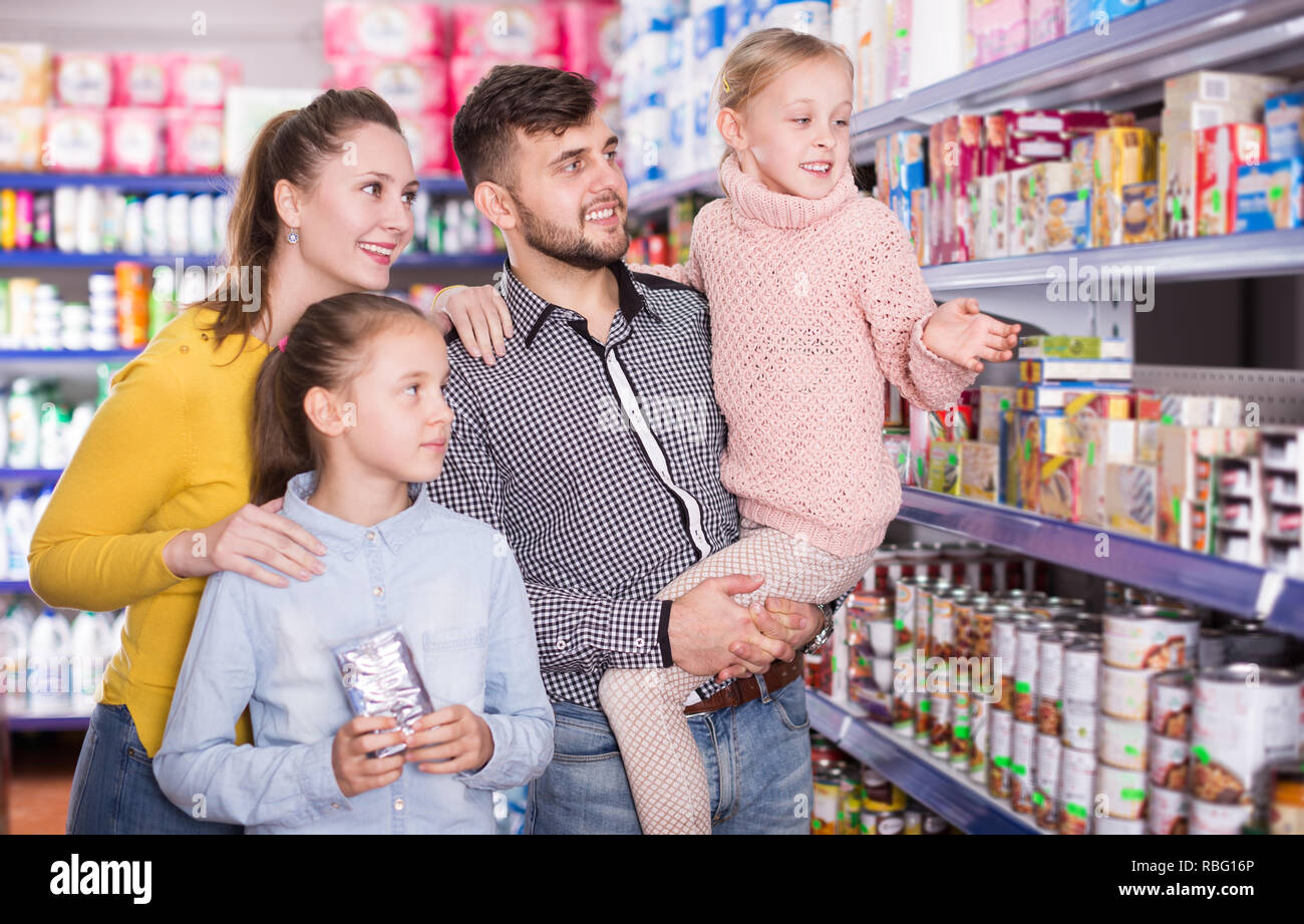 Portrait of the cheerful family with two daughters in food store Stock ...