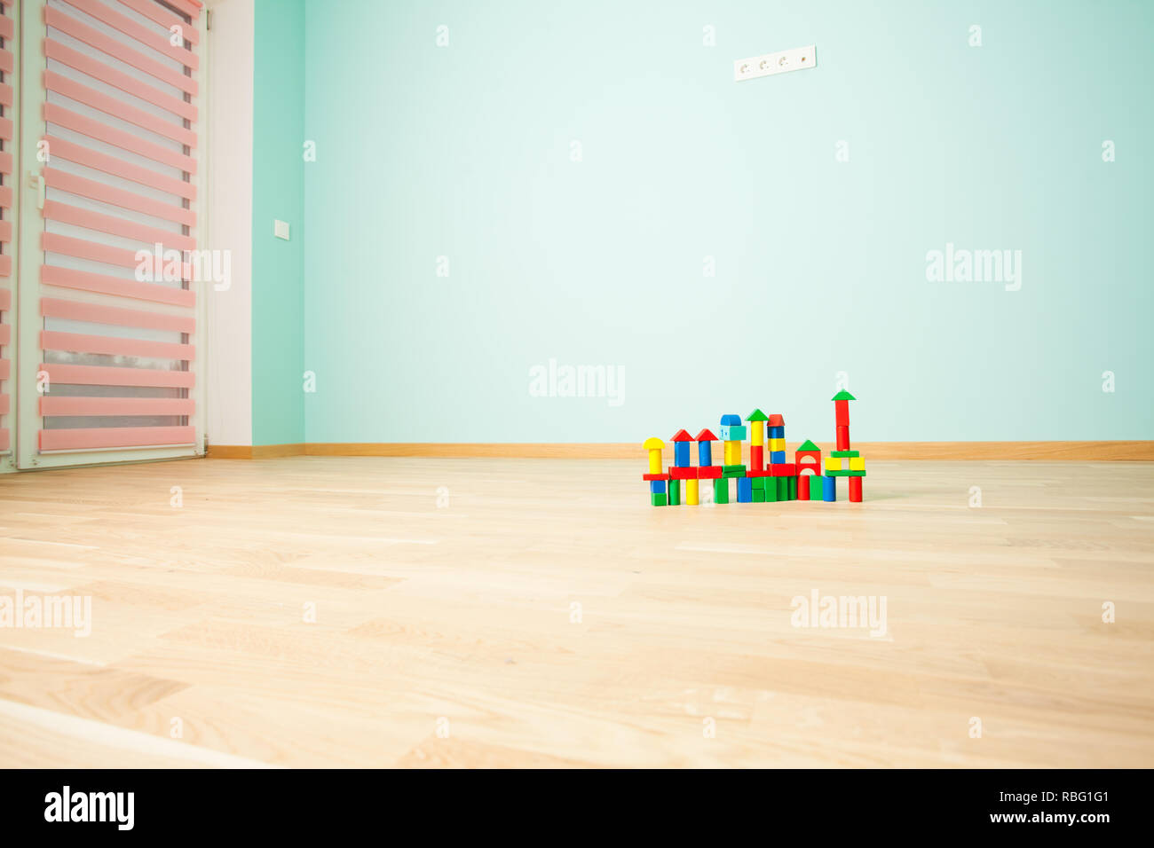 Toy castle and towers made from small colorful wooden blocks standing ...