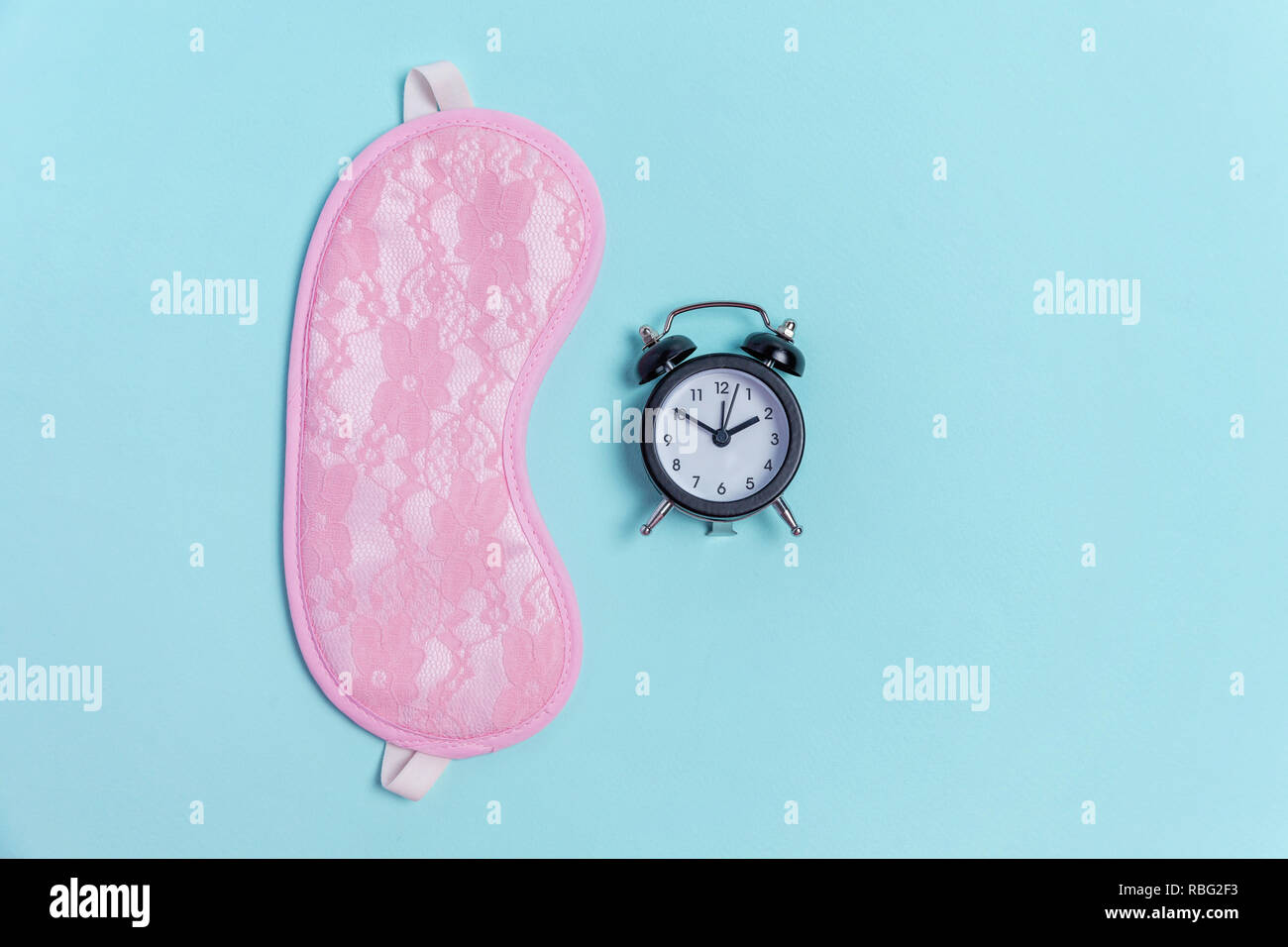 Sleeping eye mask, alarm clock isolated on blue pastel colourful trendy ...